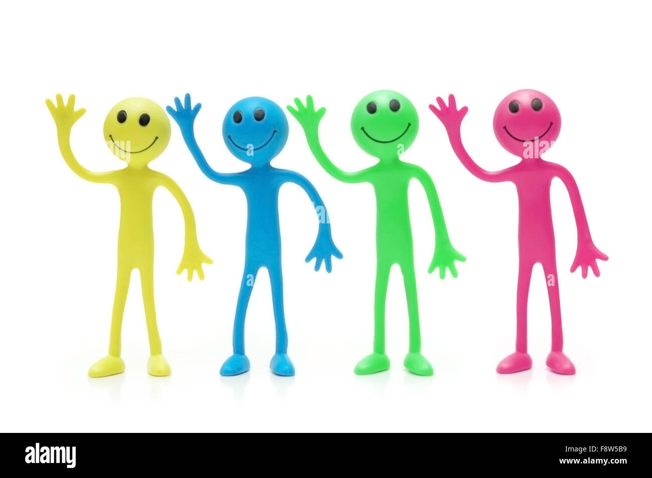 Four Smilies of various colours isolated on white Stock Photo - Alamy
