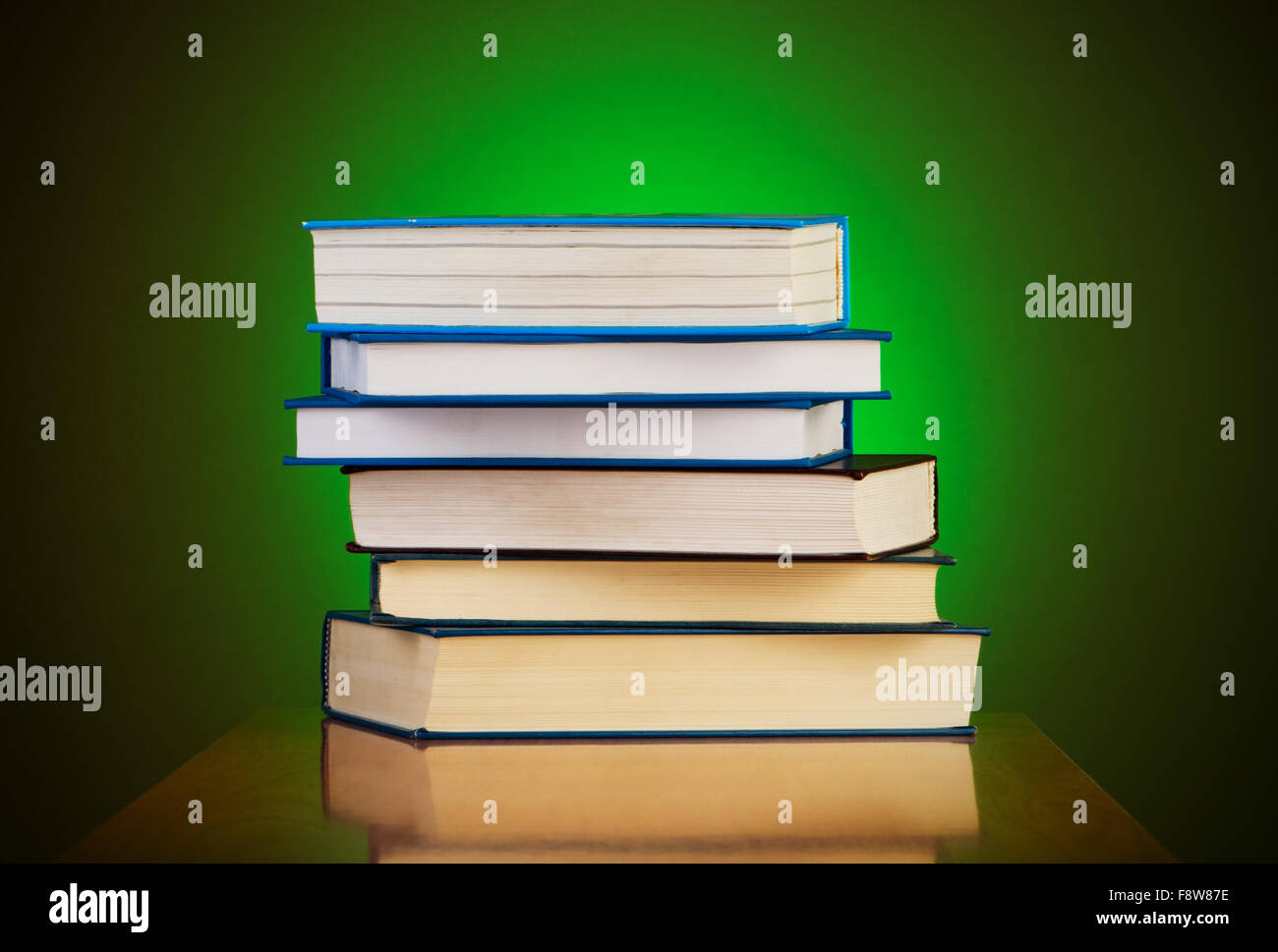 Stack of books against gradient background Stock Photo - Alamy