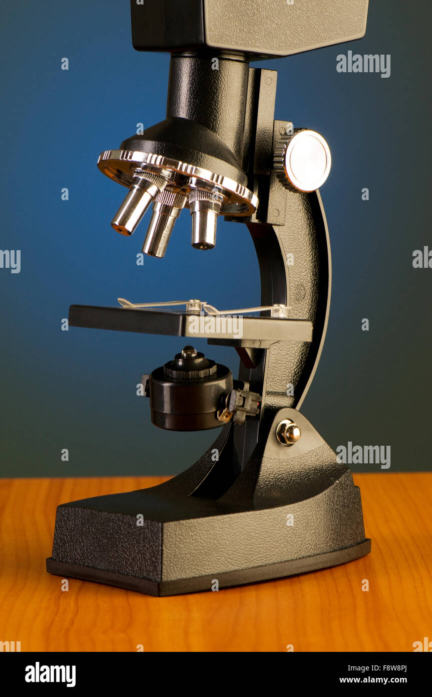 Microscope against blue gradient background Stock Photo - Alamy