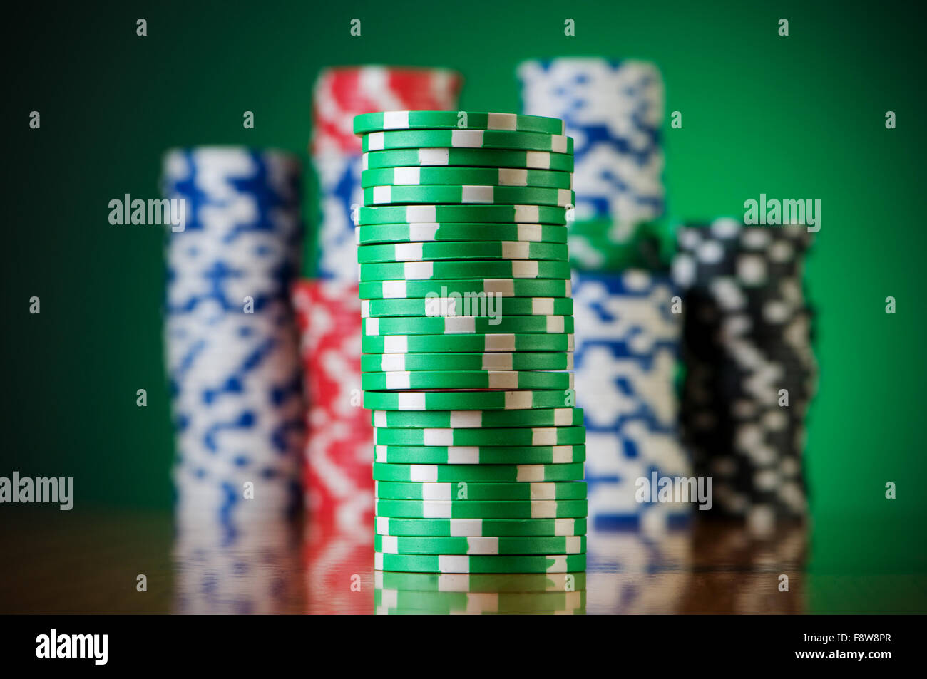 Stack of casino chips against gradient background Stock Photo - Alamy