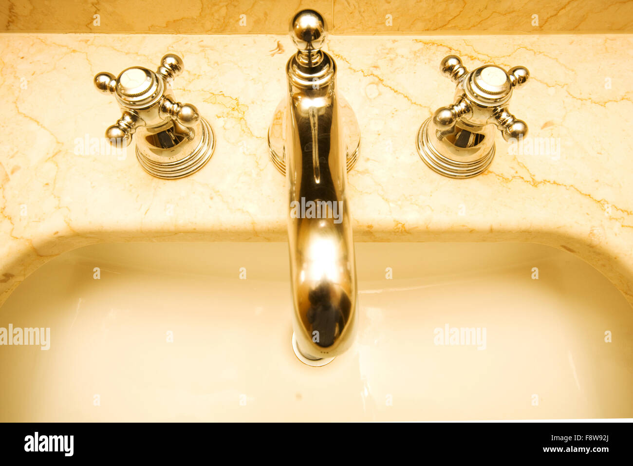 Silver shiny tap and marble sink Stock Photo - Alamy