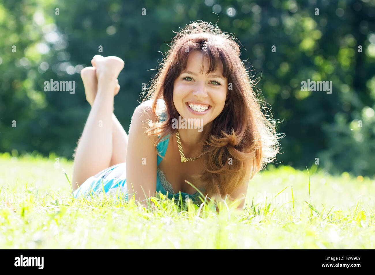 Happy woman relaxing outdoor in grass Stock Photo - Alamy