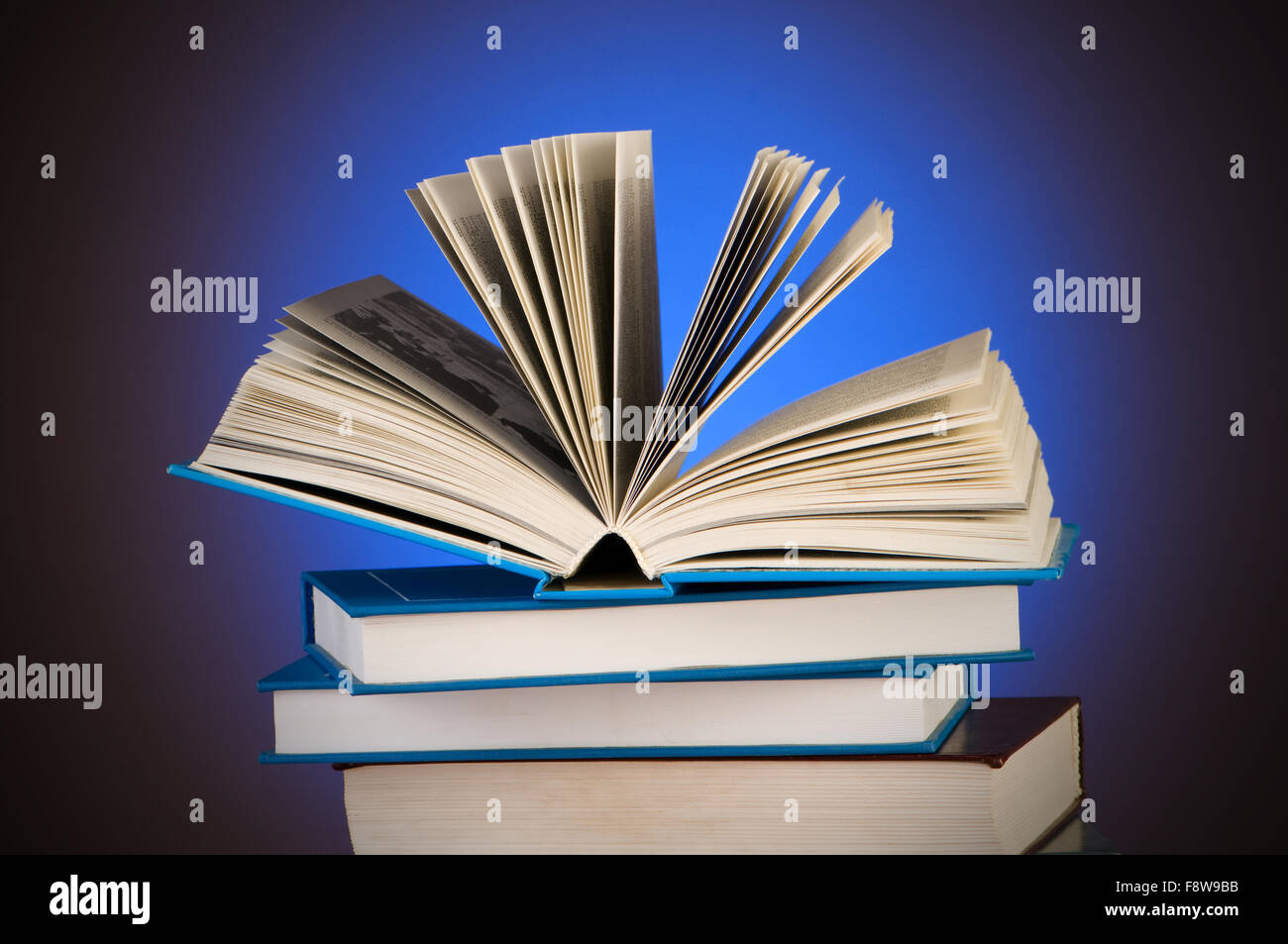 Stack of books against gradient background Stock Photo - Alamy