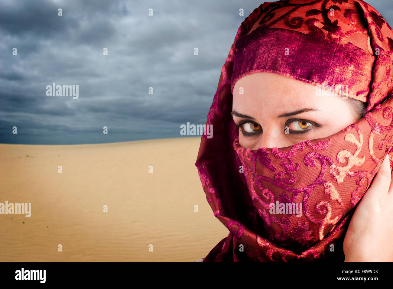 woman dressed in Arab costume, desert in the background Stock Photo - Alamy