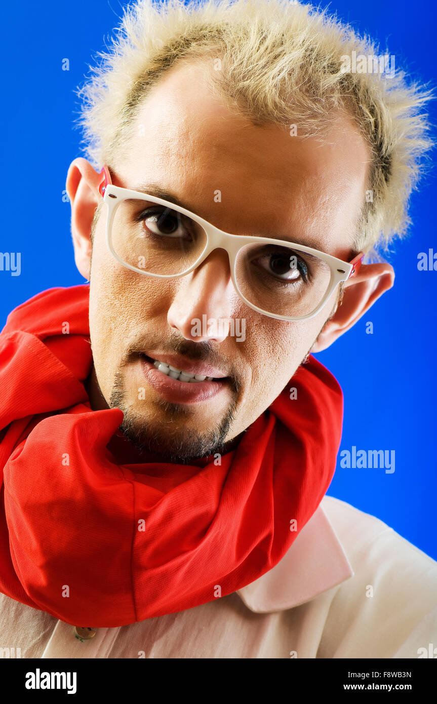 Man with red scarf against coloured background Stock Photo - Alamy
