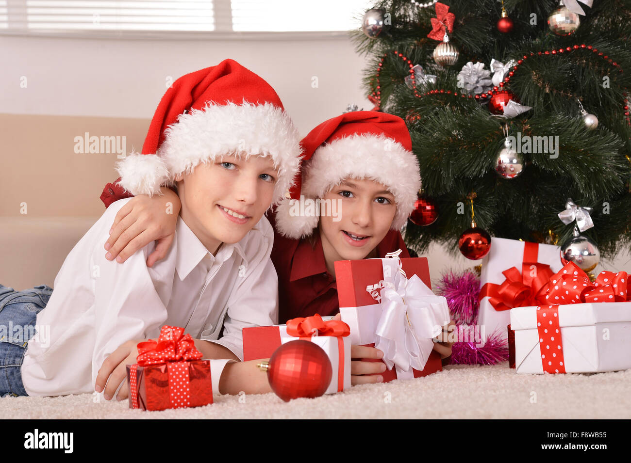 Happy kids celebrating christmas Stock Photo - Alamy