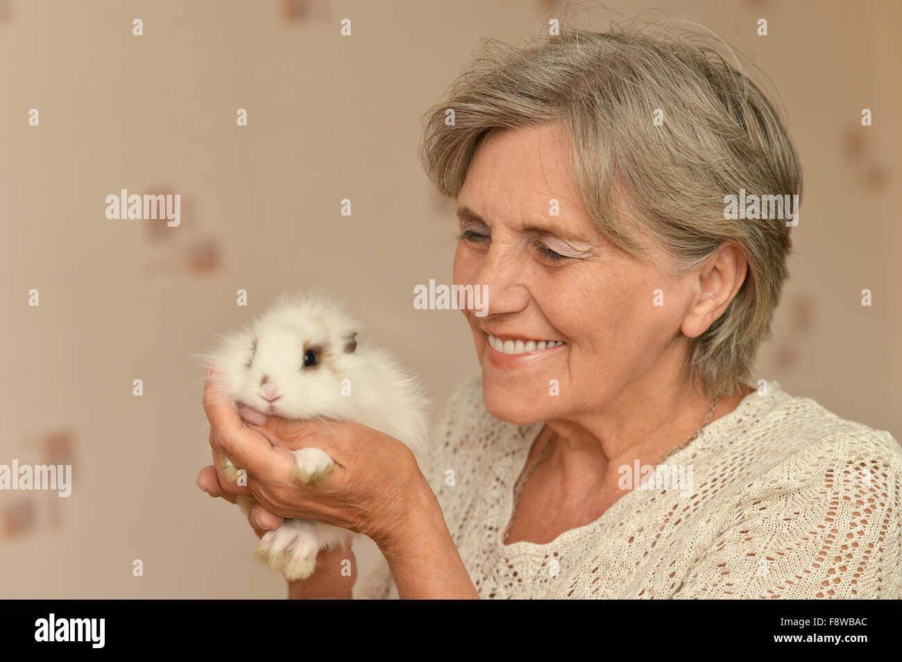 Elderly woman with rabbit Stock Photo - Alamy