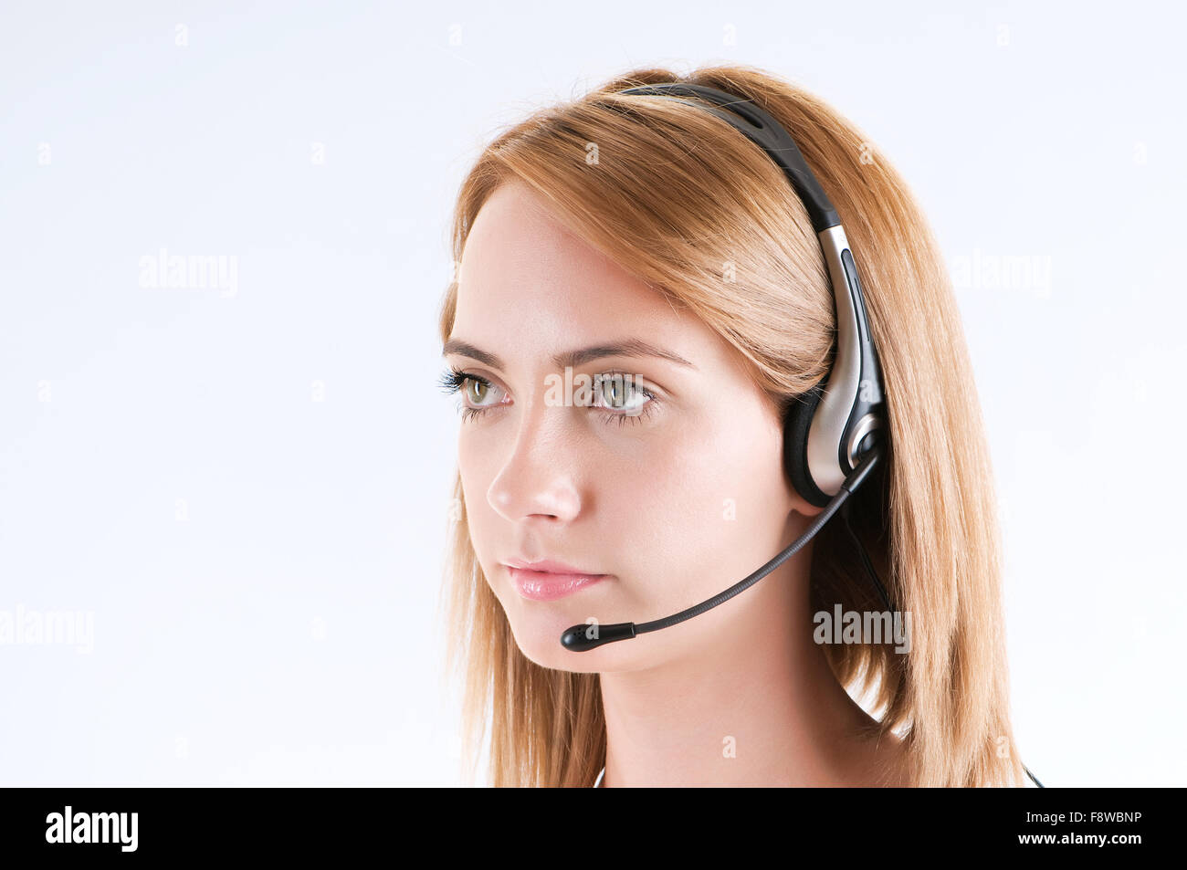 Young call center operator with the headset Stock Photo - Alamy