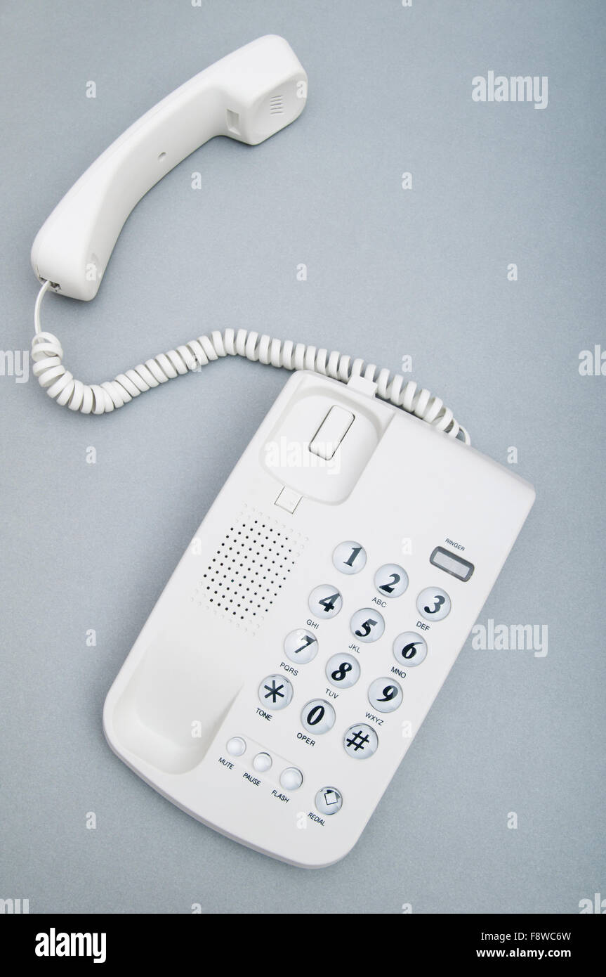 White office phone on the flat surface Stock Photo - Alamy