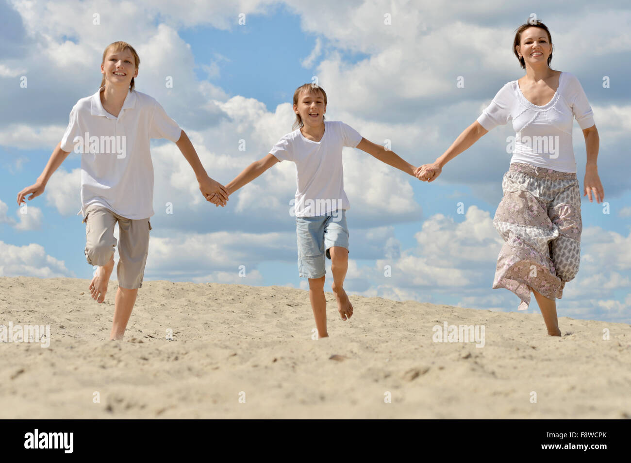 Family on beach in summer day Stock Photo - Alamy