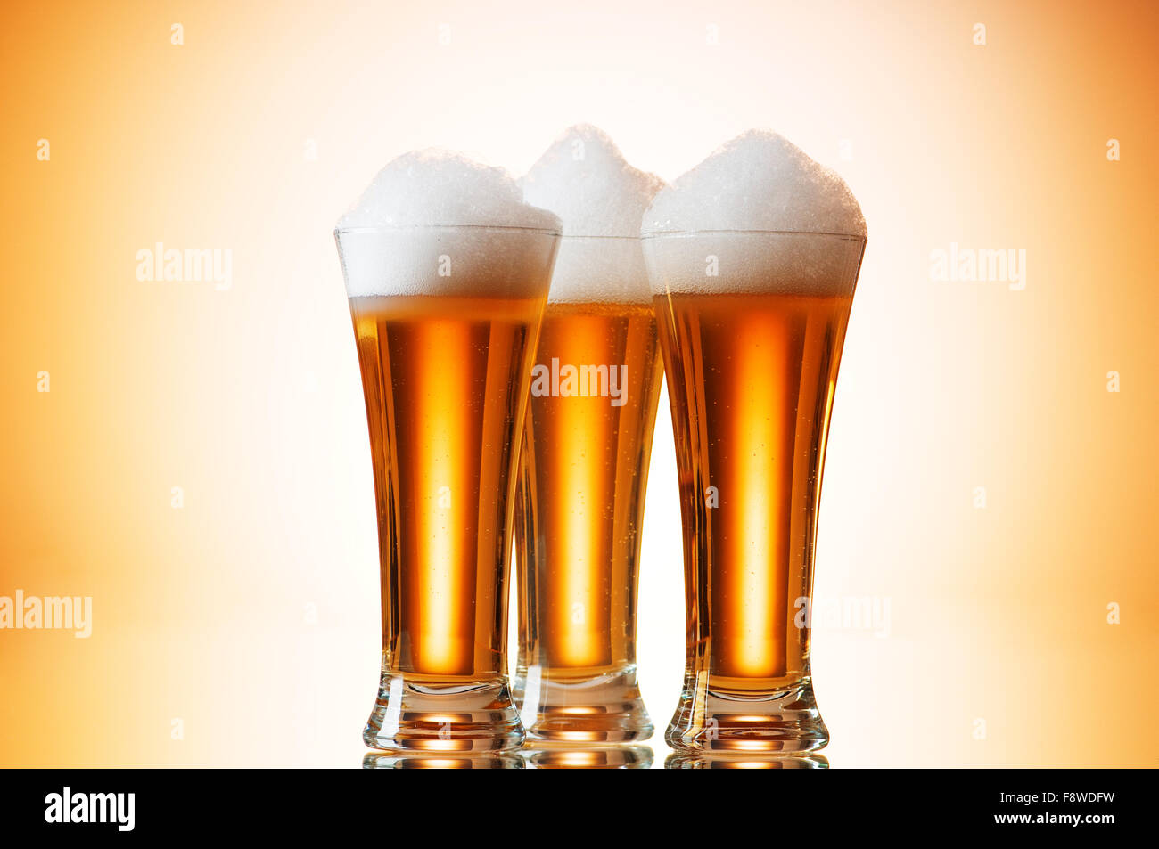 Beer glasses against the colorful gradient background Stock Photo - Alamy