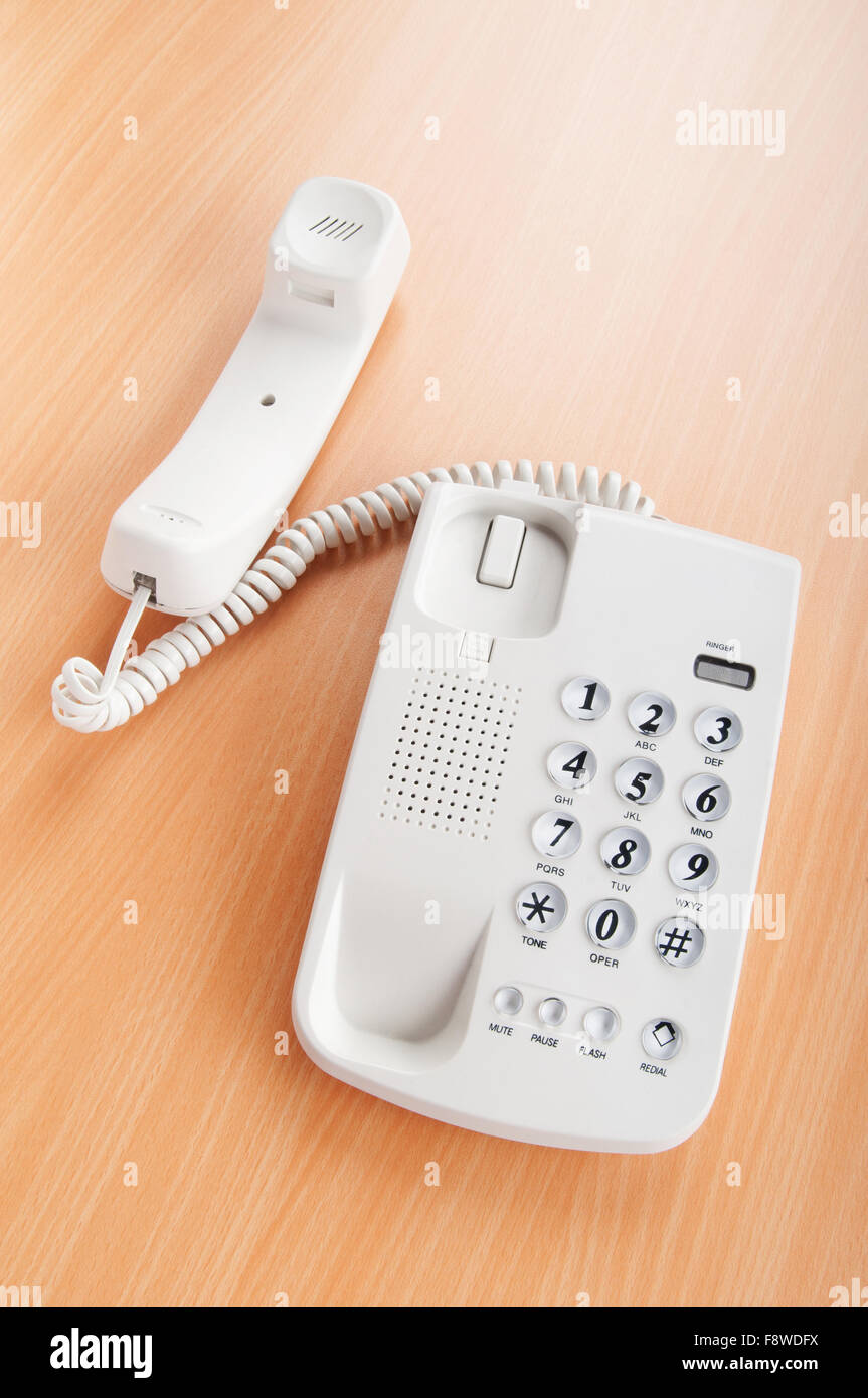 White office phone on the flat surface Stock Photo - Alamy
