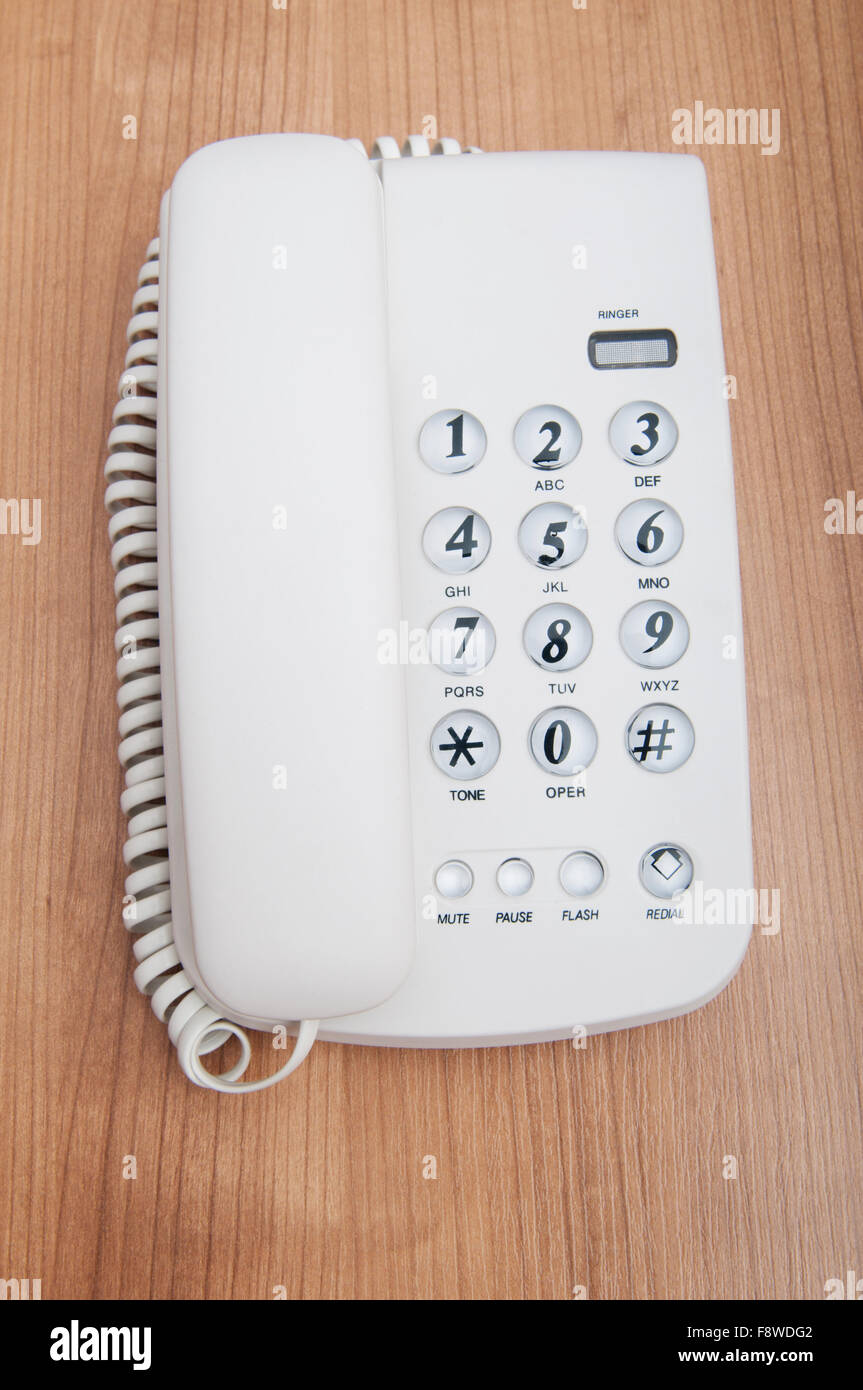 White office phone on the flat surface Stock Photo - Alamy