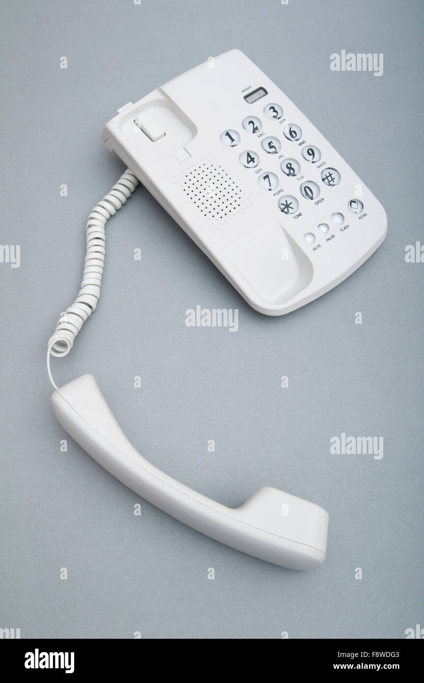White office phone on the flat surface Stock Photo - Alamy