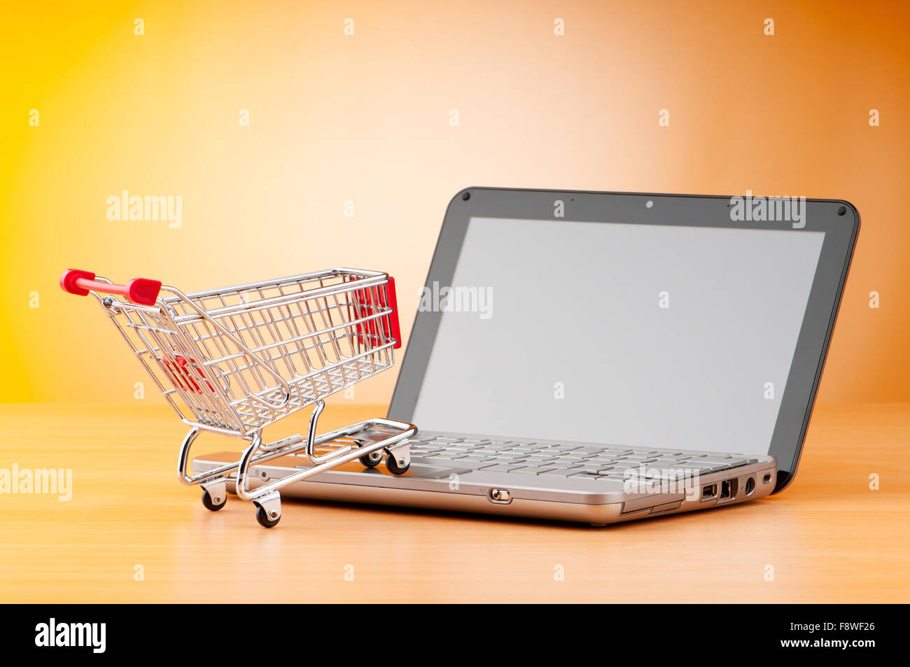 Internet online shopping concept with computer and cart Stock Photo - Alamy