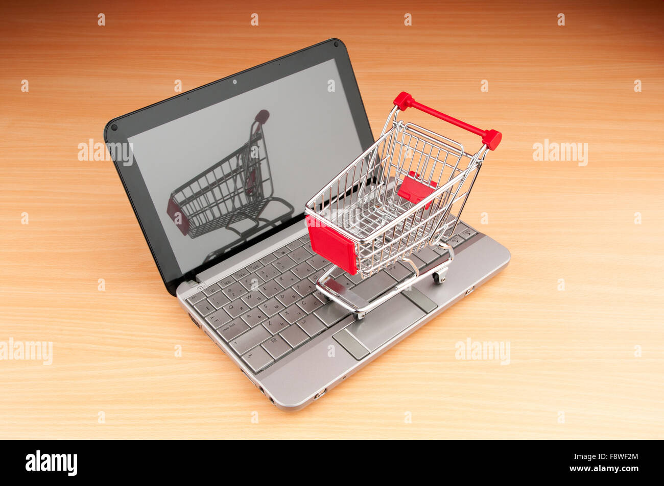 Internet online shopping concept with computer and cart Stock Photo - Alamy