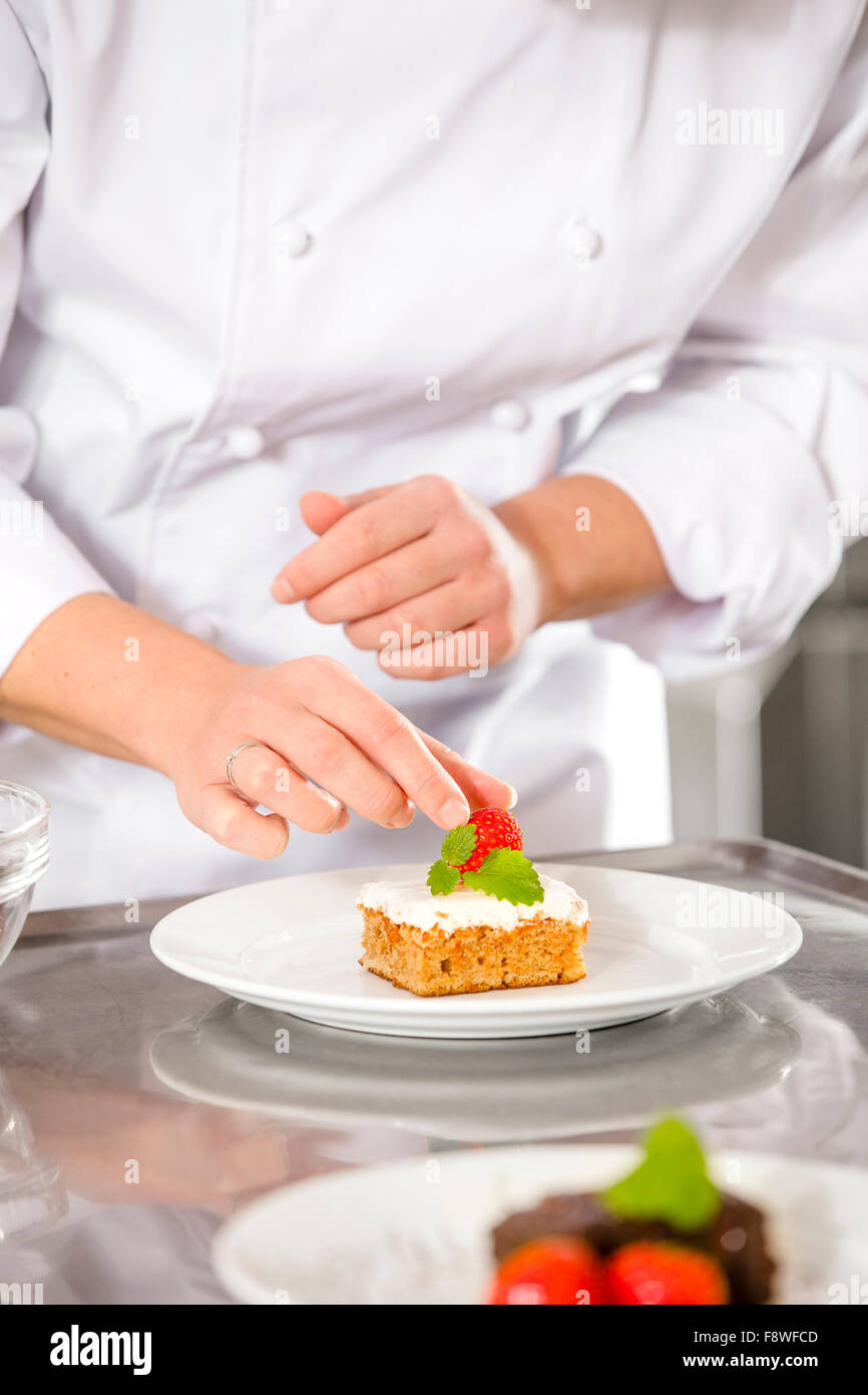 Chef decorate dessert cake with strawberry Stock Photo - Alamy