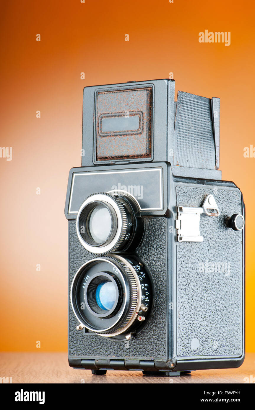Vintage film camera against gradient background Stock Photo - Alamy