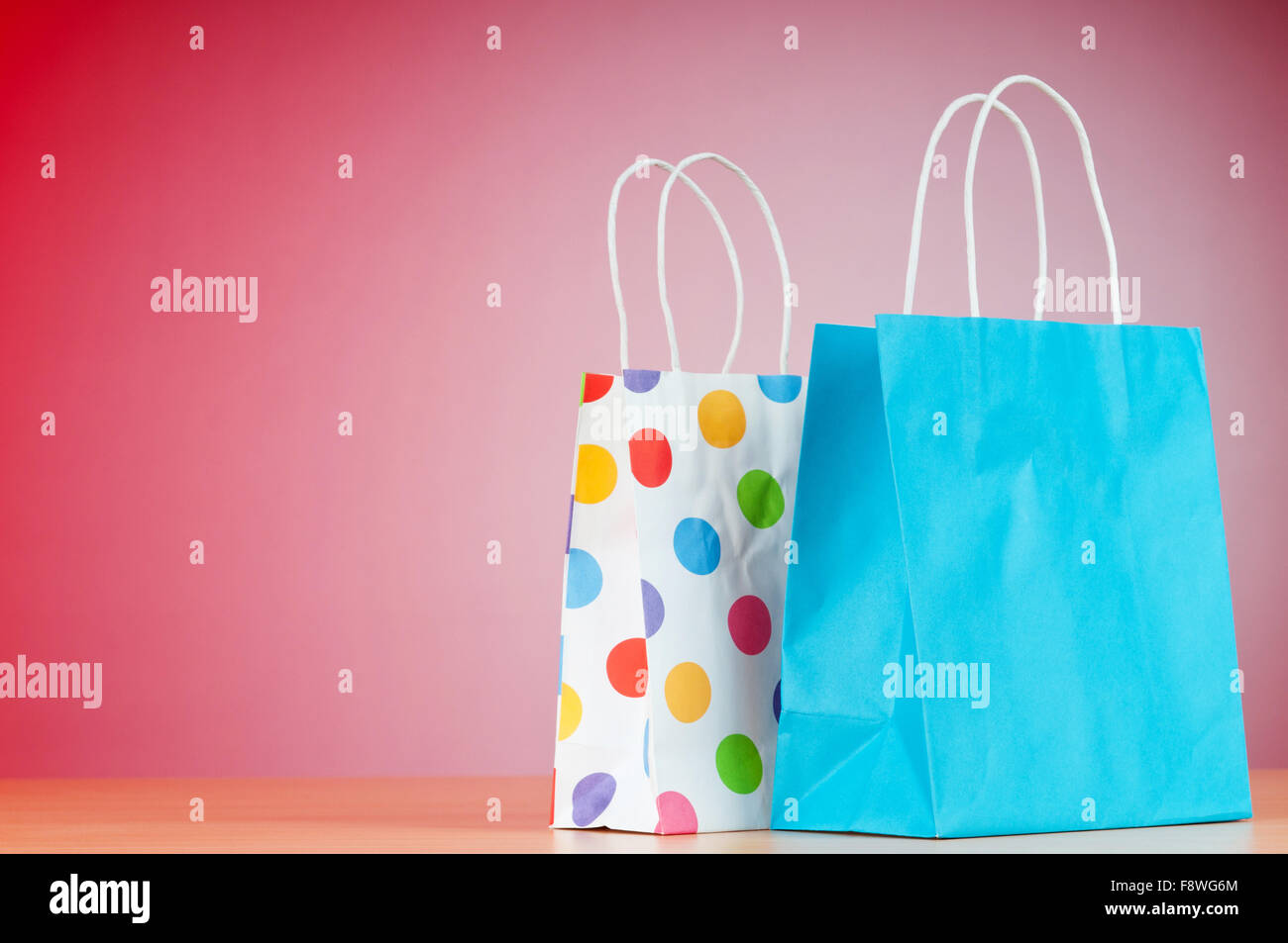 Colourful paper shopping bags against gradient background Stock Photo ...