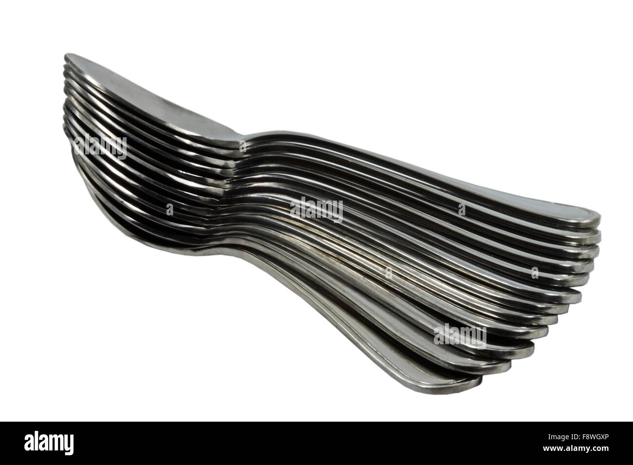 Pile of Spoons facing at angle isolated Stock Photo - Alamy