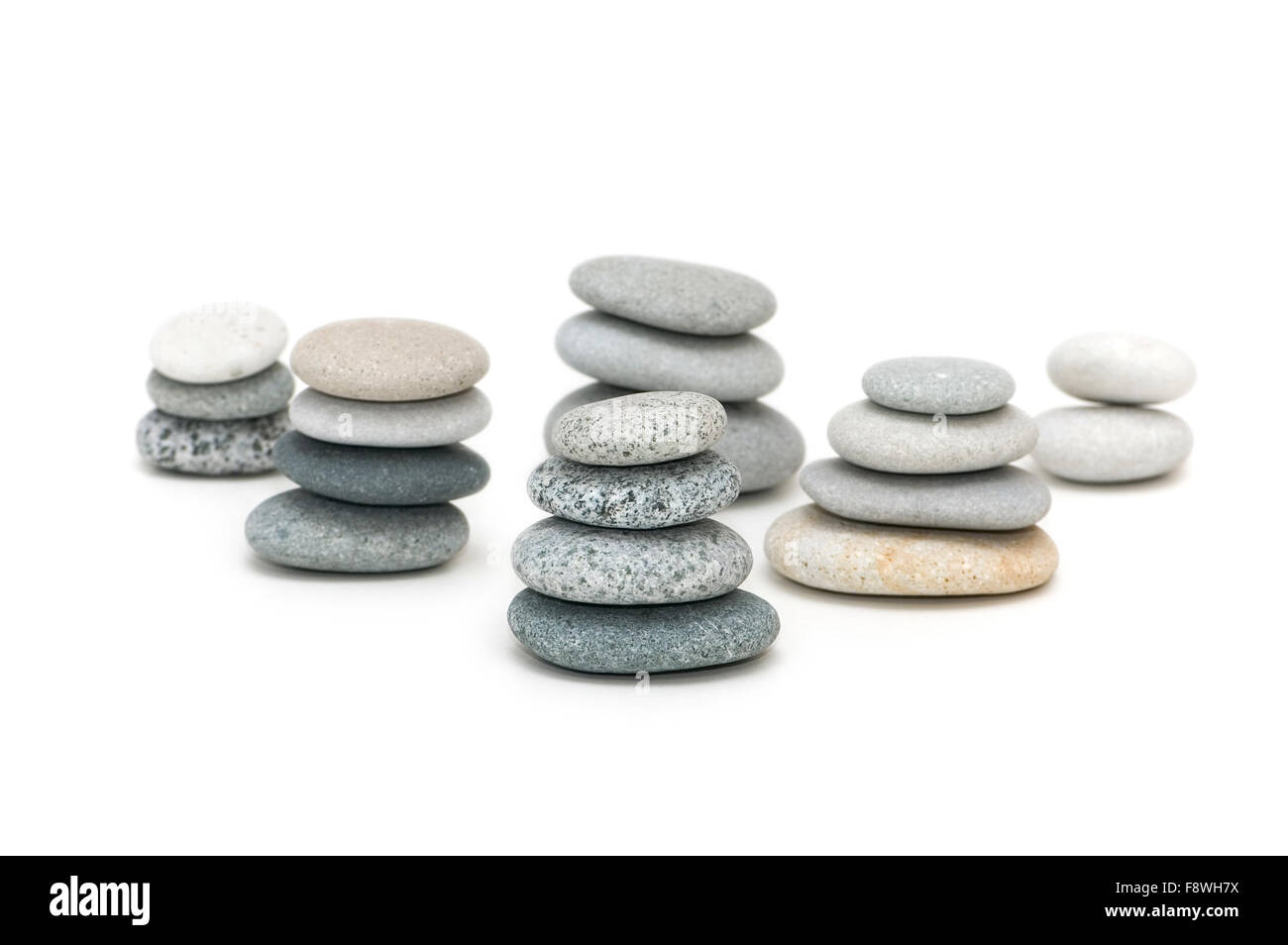 Stacks of pebbles isolated on the white Stock Photo - Alamy