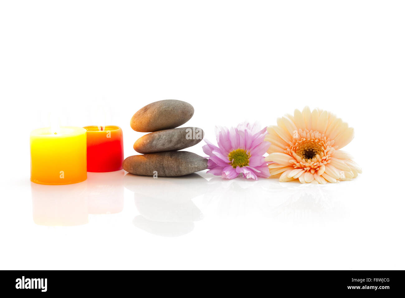 Flowers, candle, stones - spa theme Stock Photo - Alamy