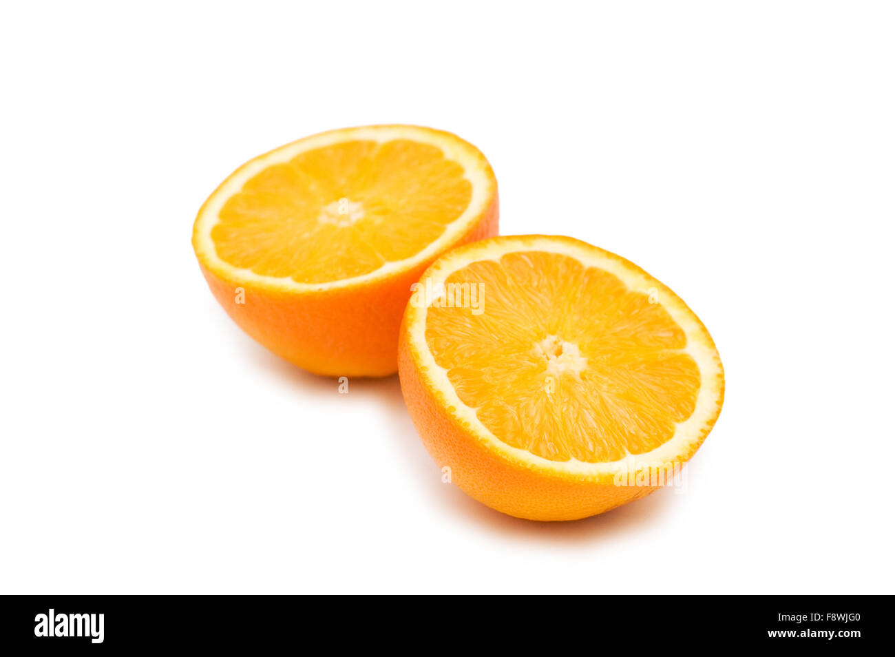 Two half-cut oranges isolated on white background Stock Photo - Alamy