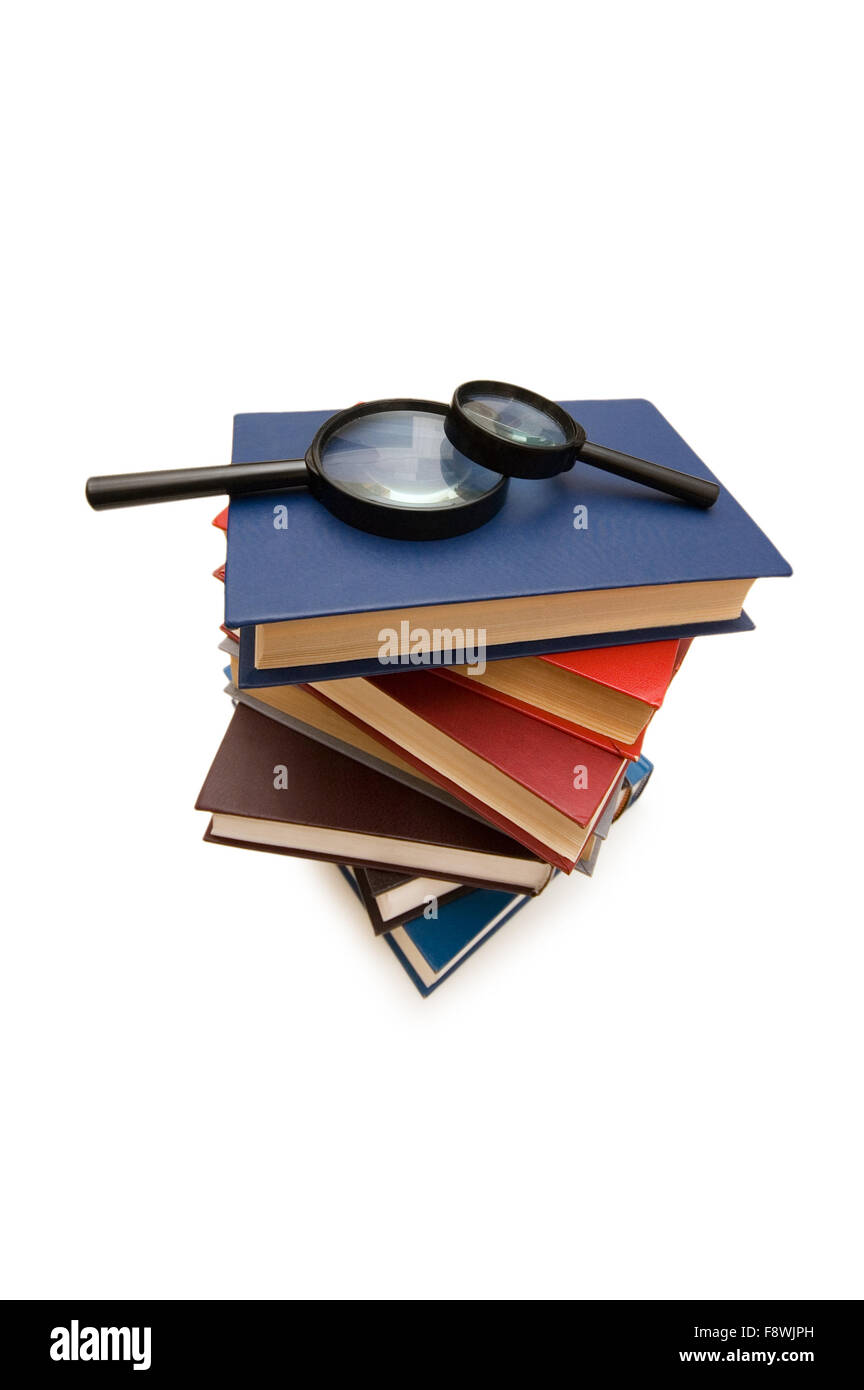 Magnifying glass over the stack of books Stock Photo - Alamy