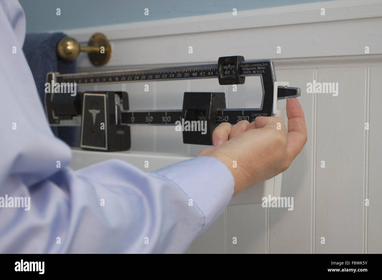 finger on weight scale Stock Photo - Alamy