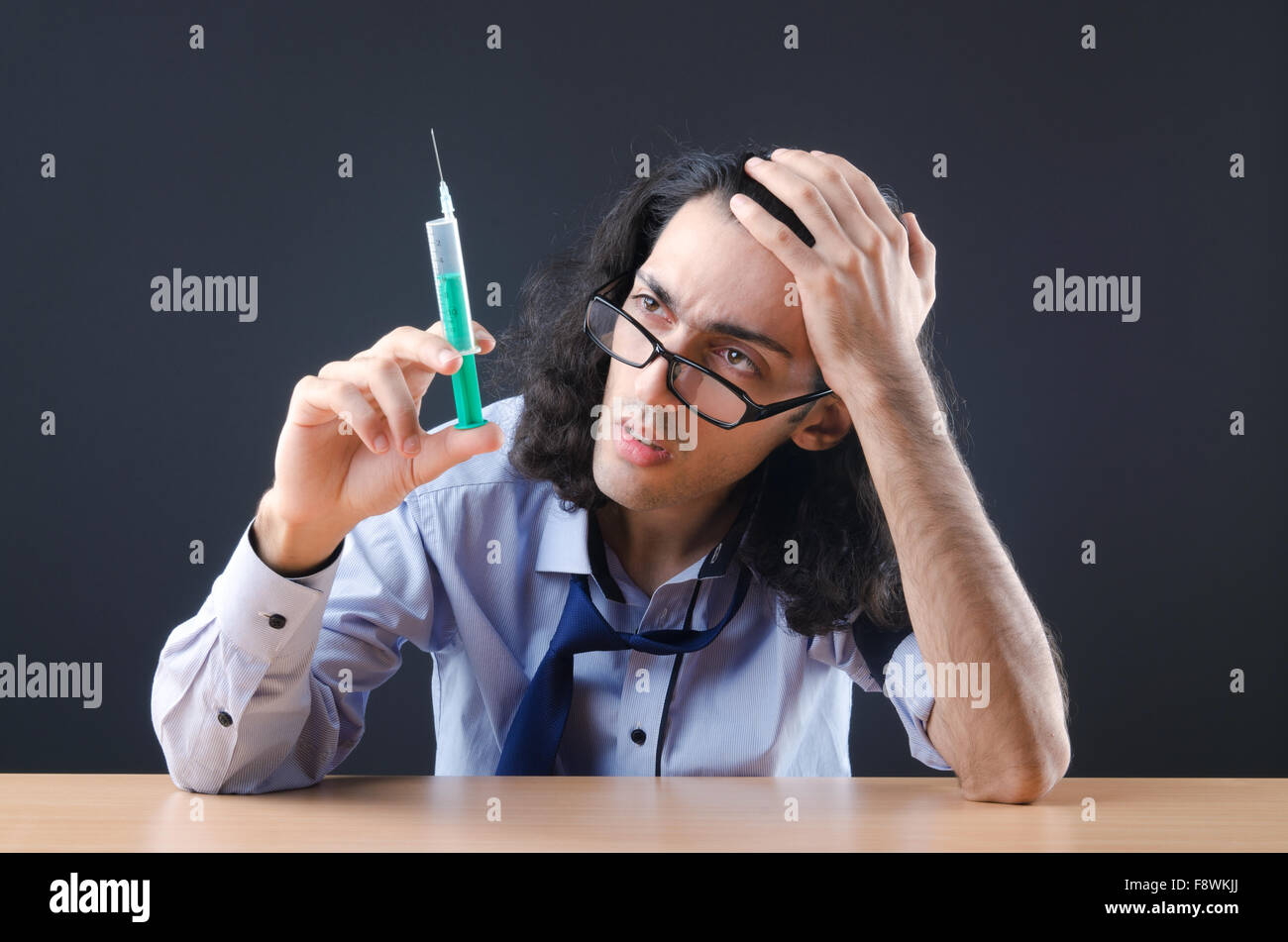 Young druc addict with syringe Stock Photo - Alamy
