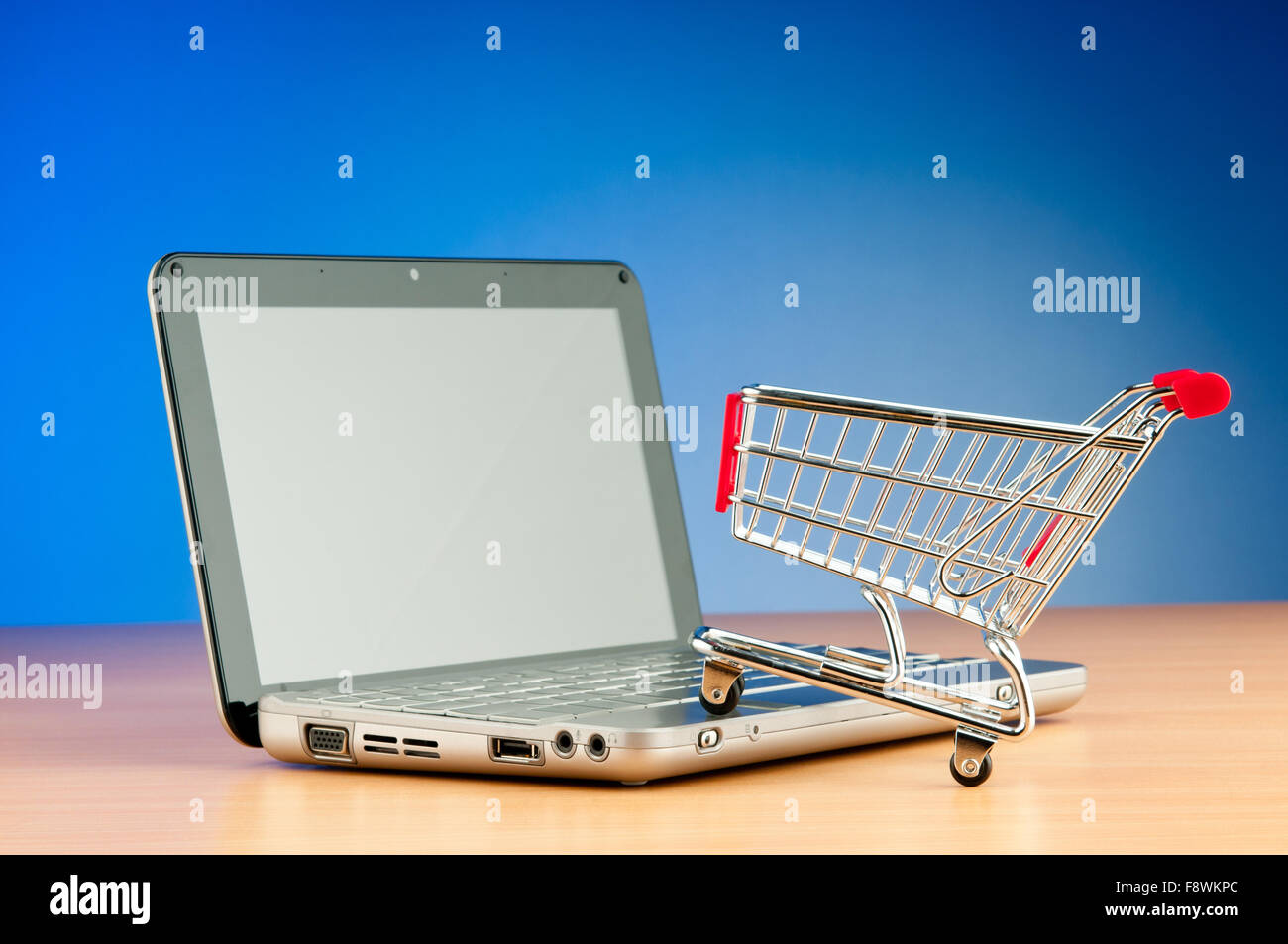 Internet online shopping concept with computer and cart Stock Photo - Alamy