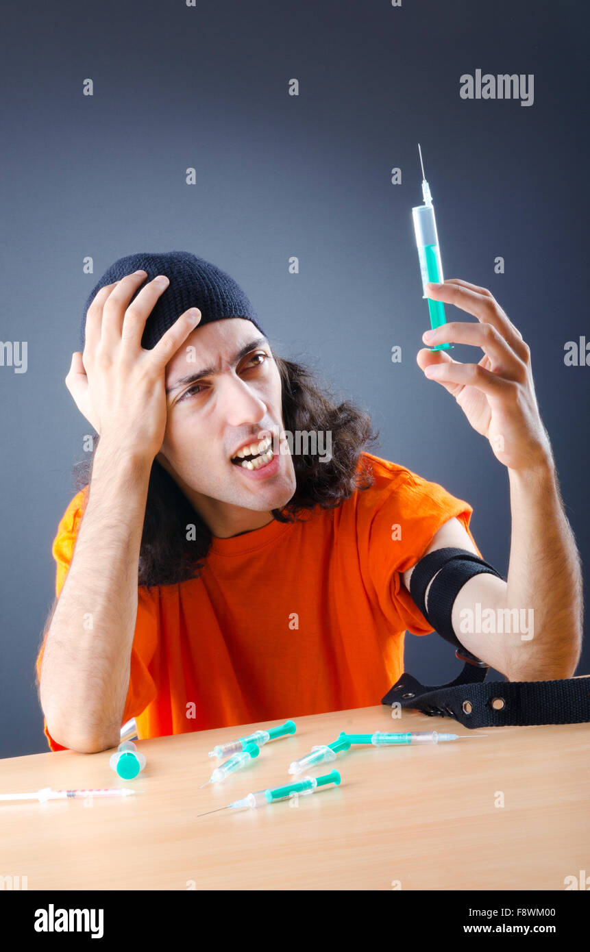Young druc addict with syringe Stock Photo - Alamy