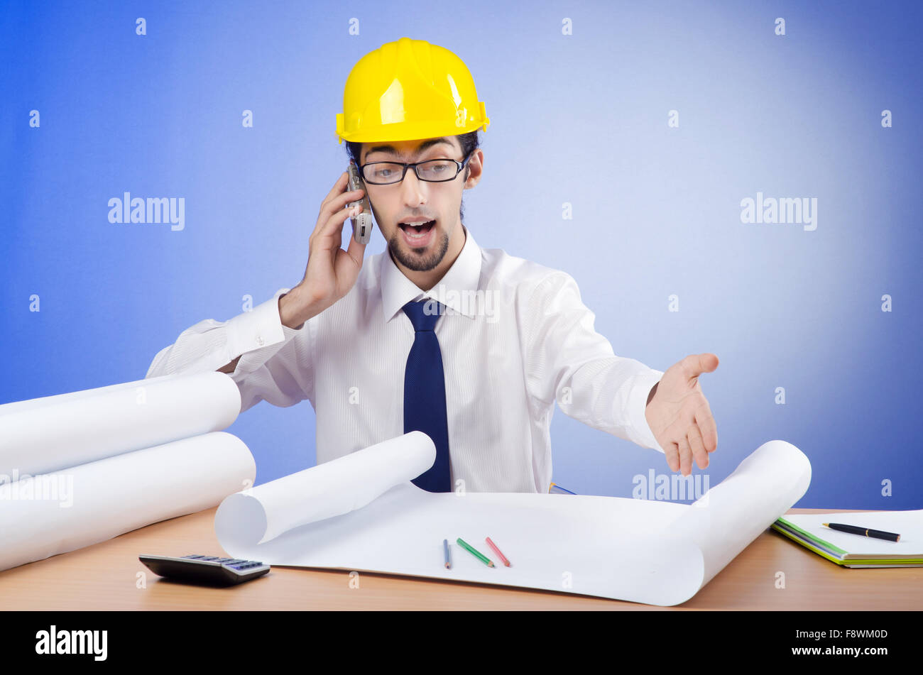 Young engineer looking at drawings Stock Photo - Alamy