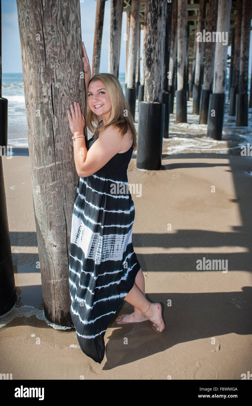 Female teen full body pose facing pier piling Stock Photo - Alamy