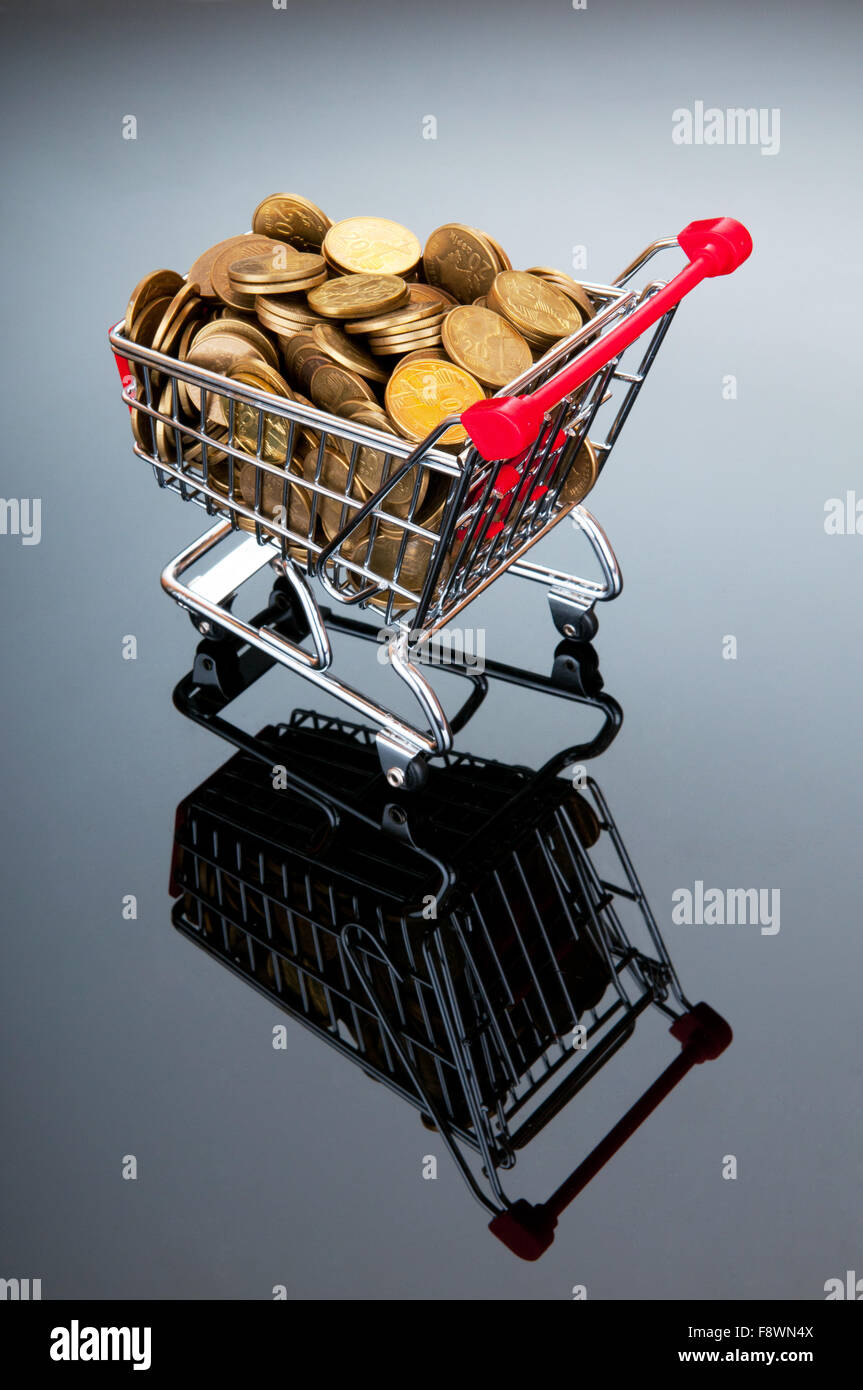 Shopping cart and gold coins Stock Photo - Alamy