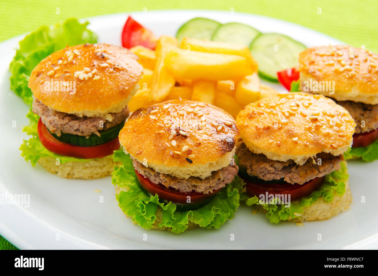 Plate with tasty mini burgers Stock Photo - Alamy