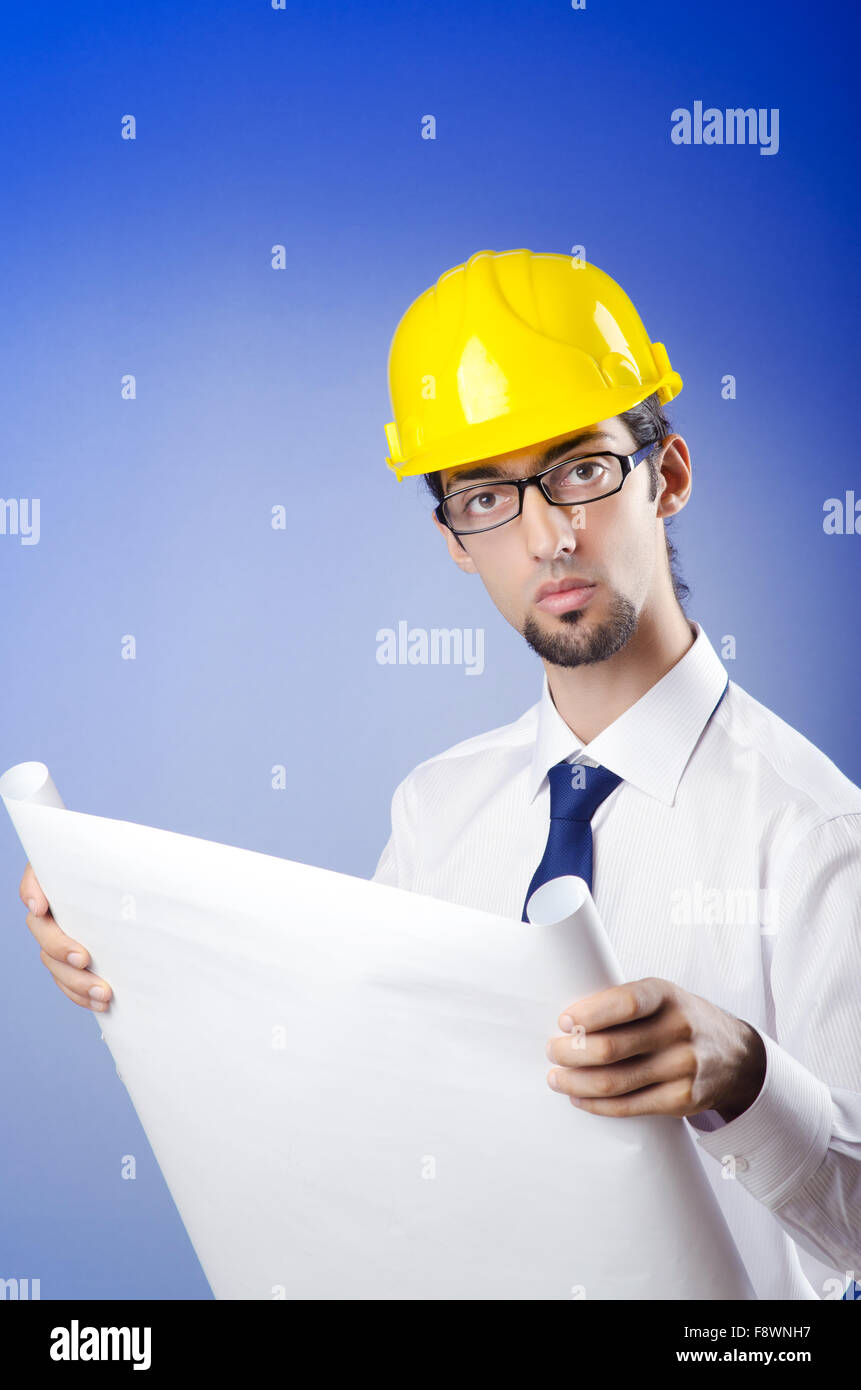 Young engineer looking at drawings Stock Photo - Alamy