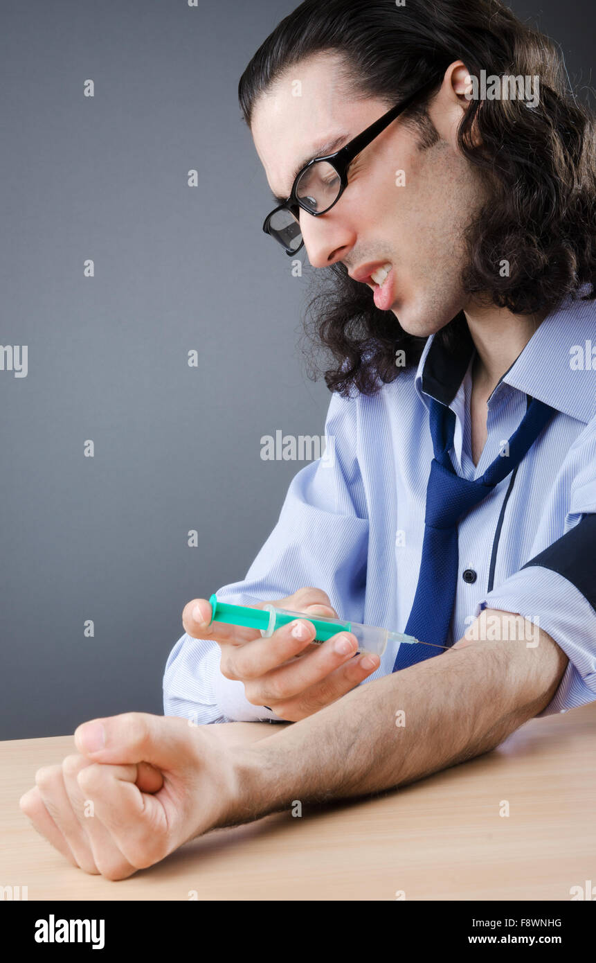 Young druc addict with syringe Stock Photo - Alamy