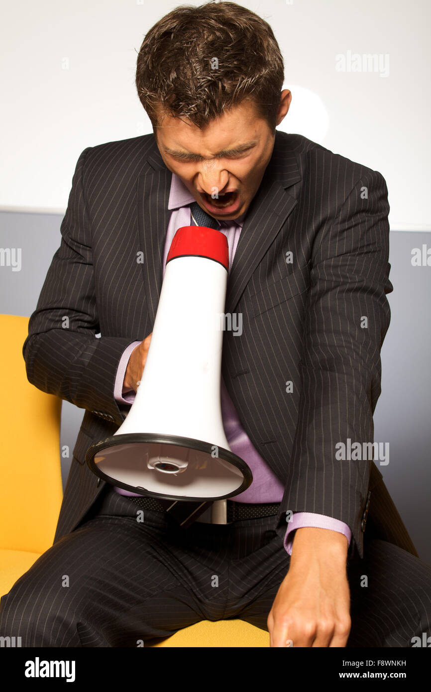 Businessman shouting through megaphone Stock Photo - Alamy