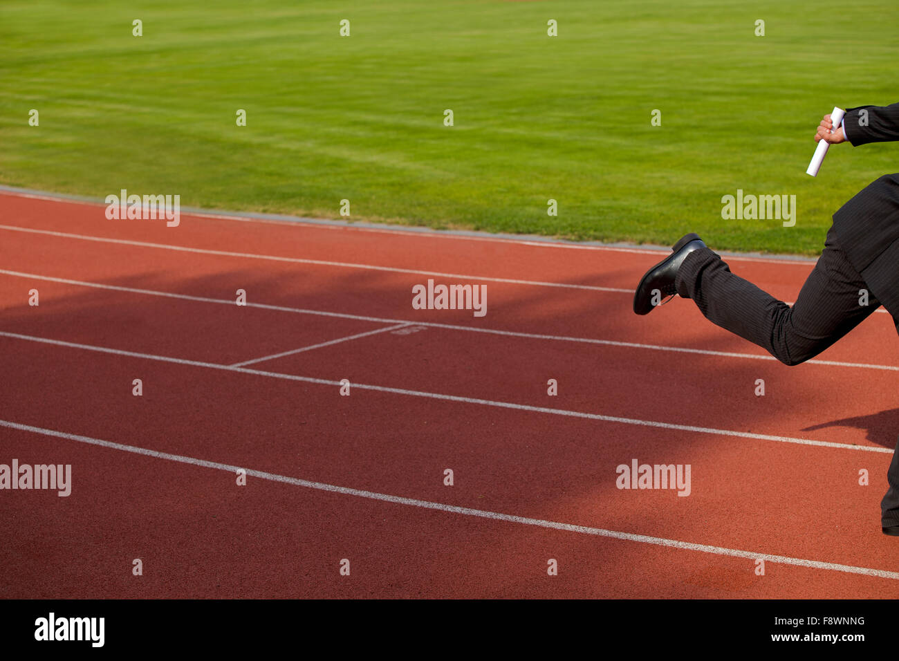 Businessman running on race track Stock Photo - Alamy