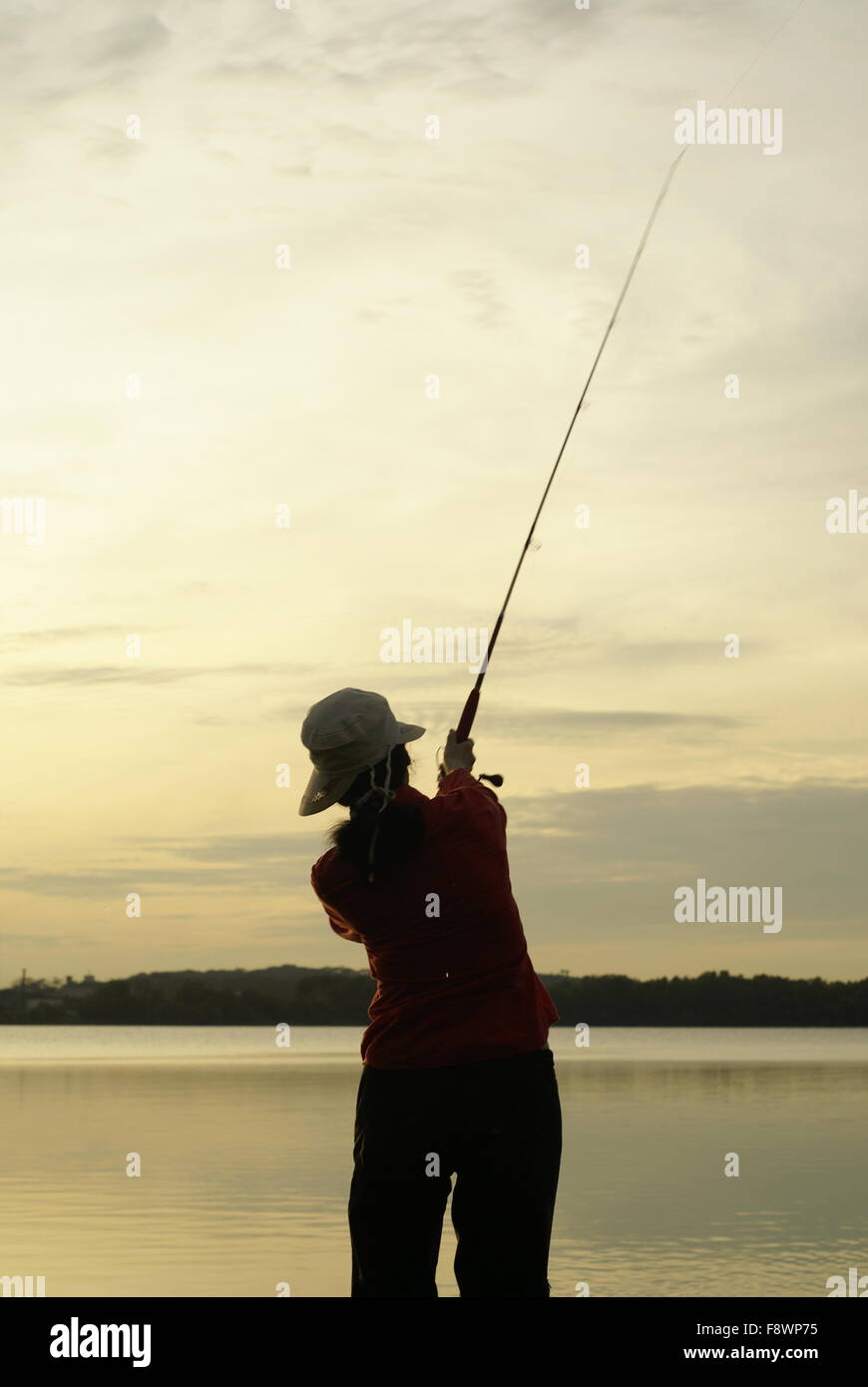 Early morning fishing lady Stock Photo - Alamy