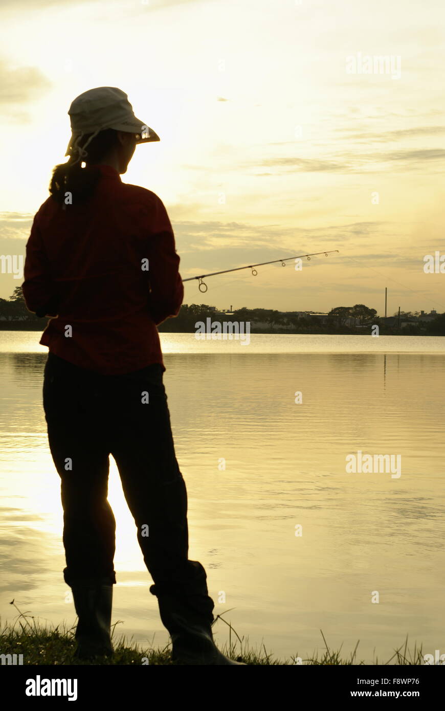 Early morning fishing lady Stock Photo - Alamy