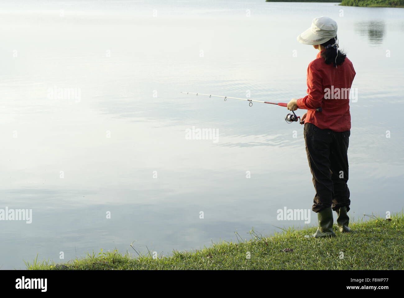 Early morning fishing lady Stock Photo - Alamy