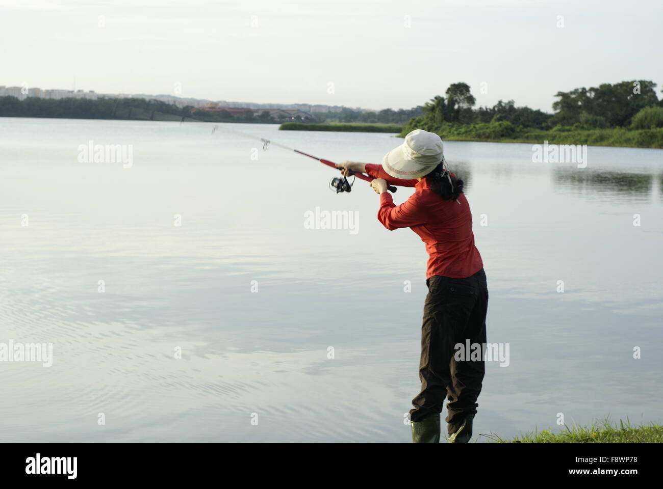 Early morning fishing lady Stock Photo - Alamy