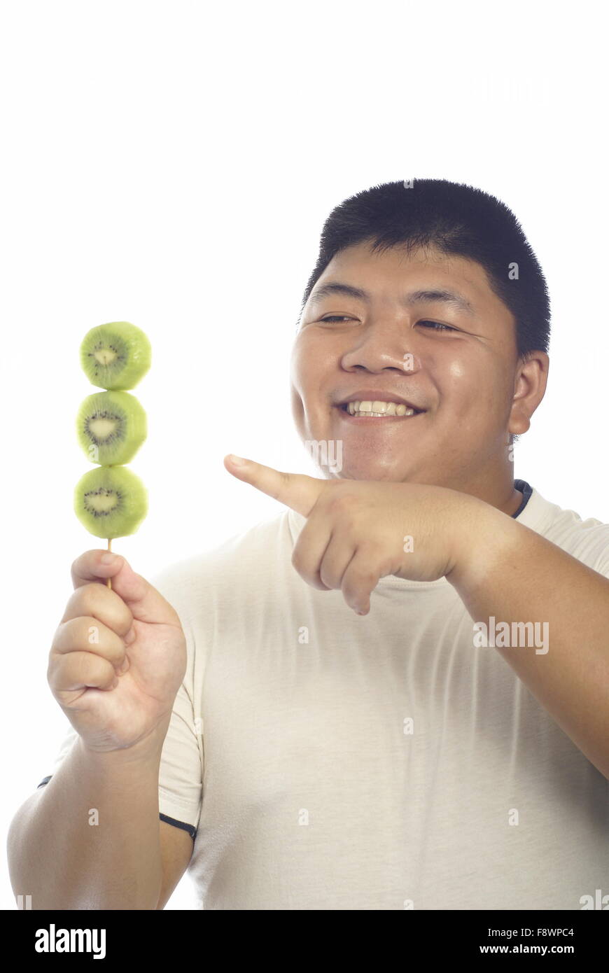 Asian man excited and pointing to green kiwi fruit Stock Photo - Alamy