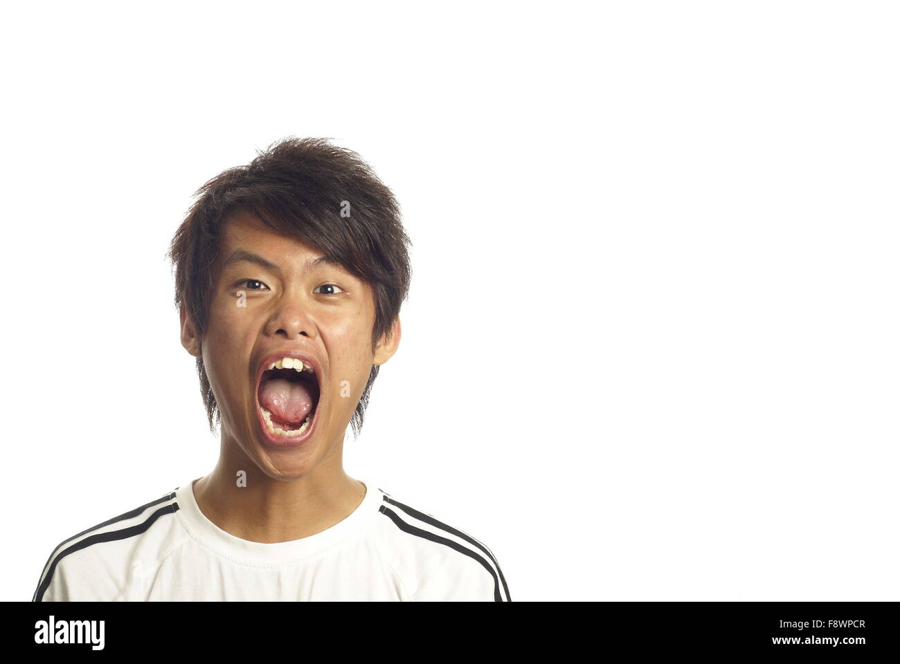 Asian man shouting out loud with white background Stock Photo - Alamy