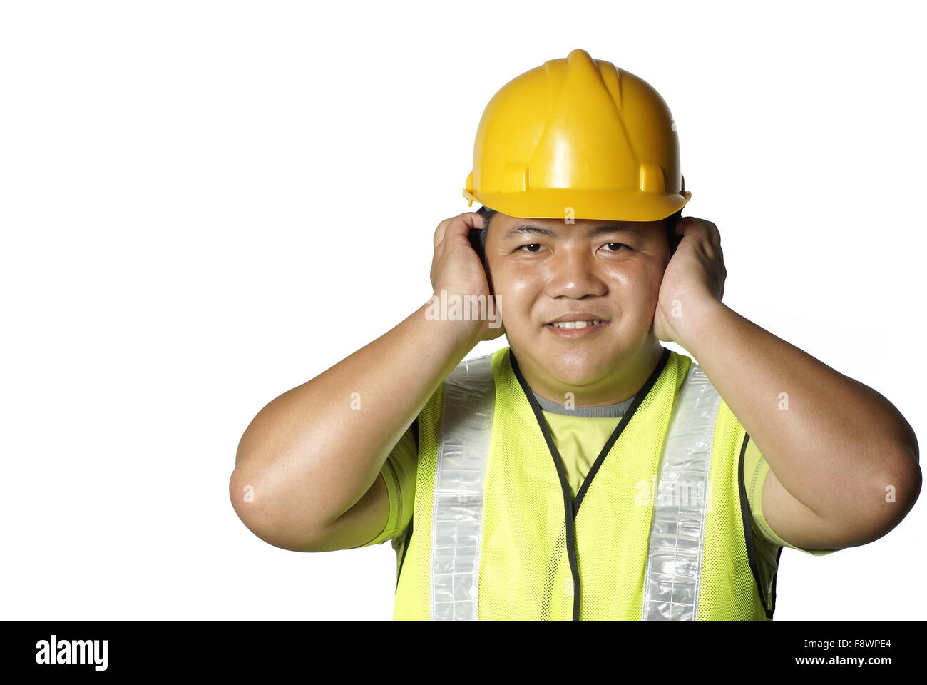 Asian construction worker covering ears Stock Photo - Alamy