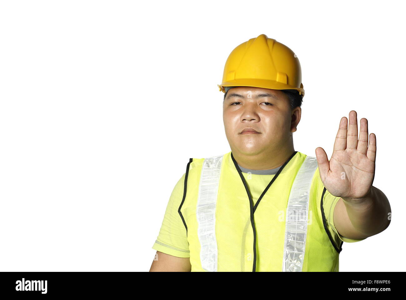 Asian construction worker with stop hand signal on white background ...