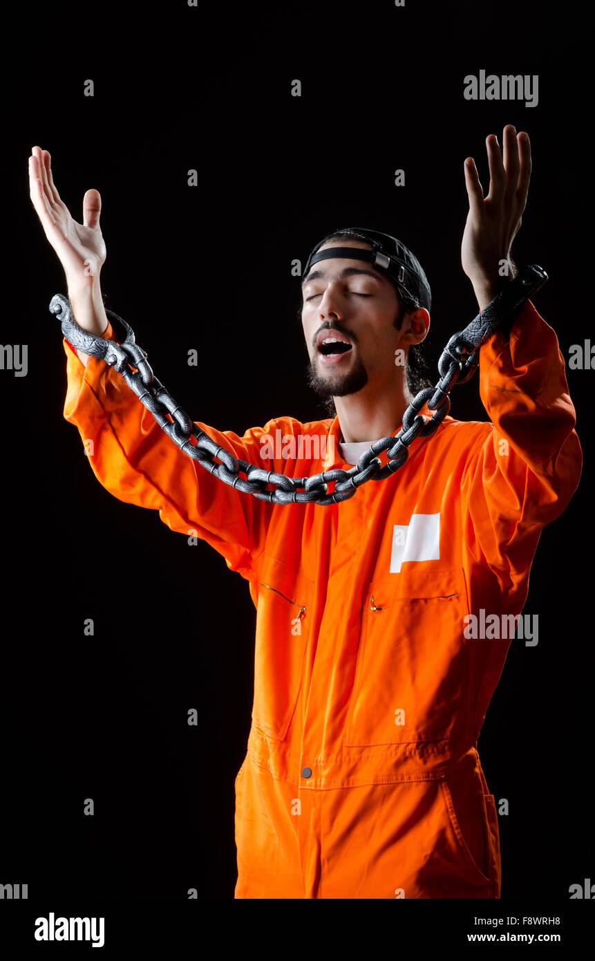 Inmate chained on black background Stock Photo - Alamy