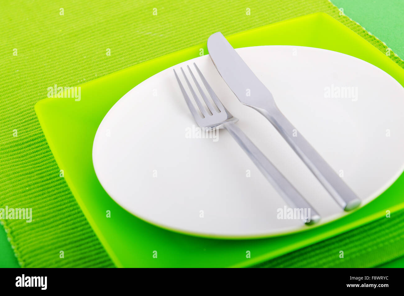 Empty plate with utensils Stock Photo - Alamy
